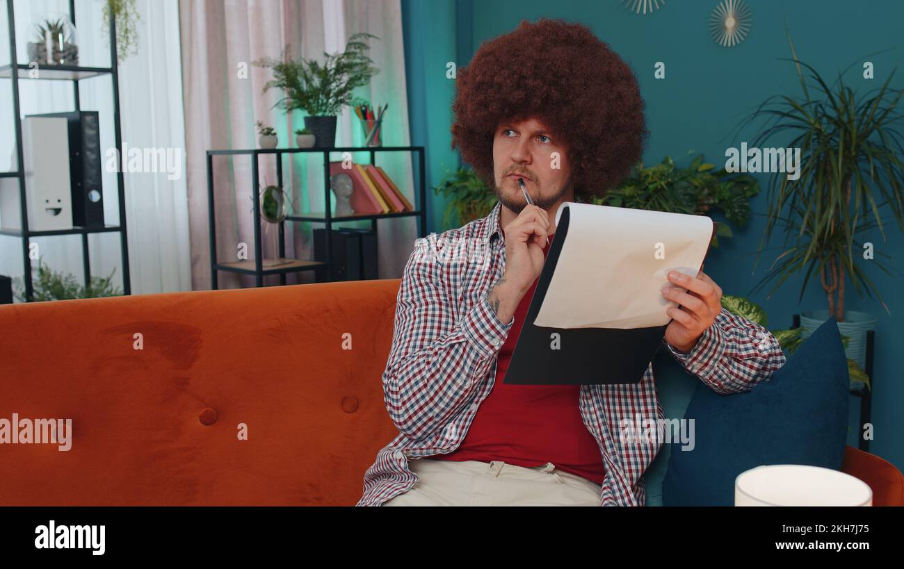 Man reading paper documents, working at home. Freelance businessman ...