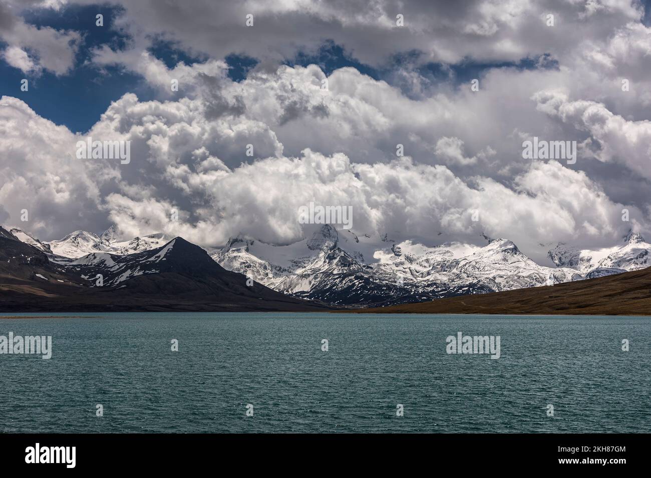 A view of the lake and mountains on a cloudy day in Tibet,China Stock ...