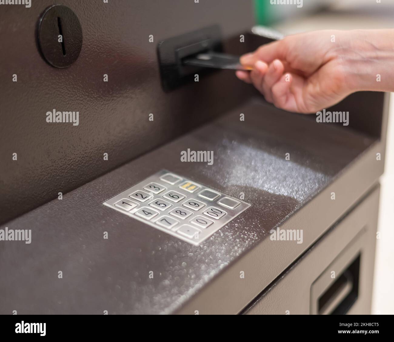 Faceless woman inserts bank card at ATM Stock Photo - Alamy