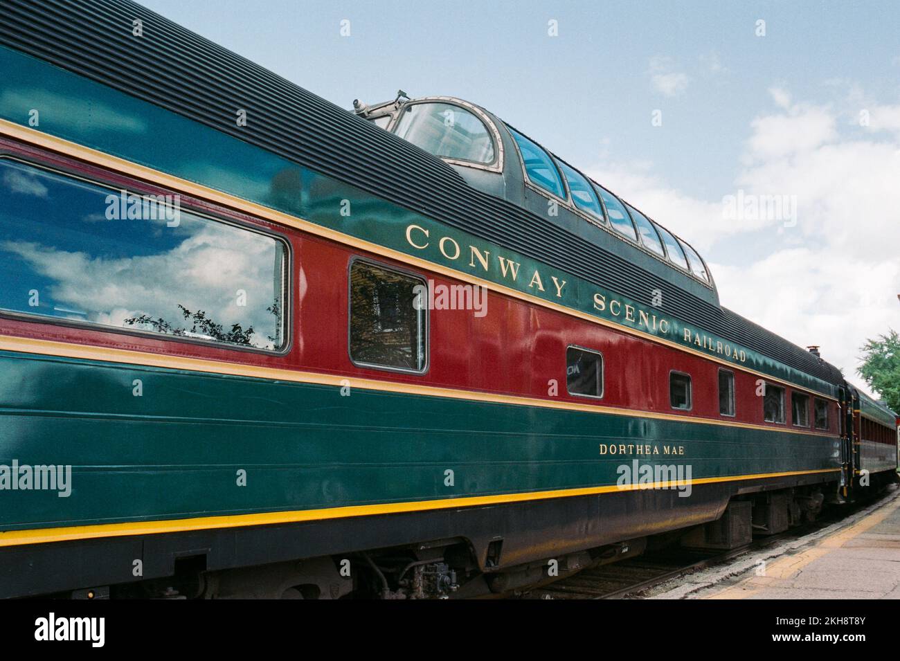 Green, red, and gold double-decker passenger car waiting for passengers ...