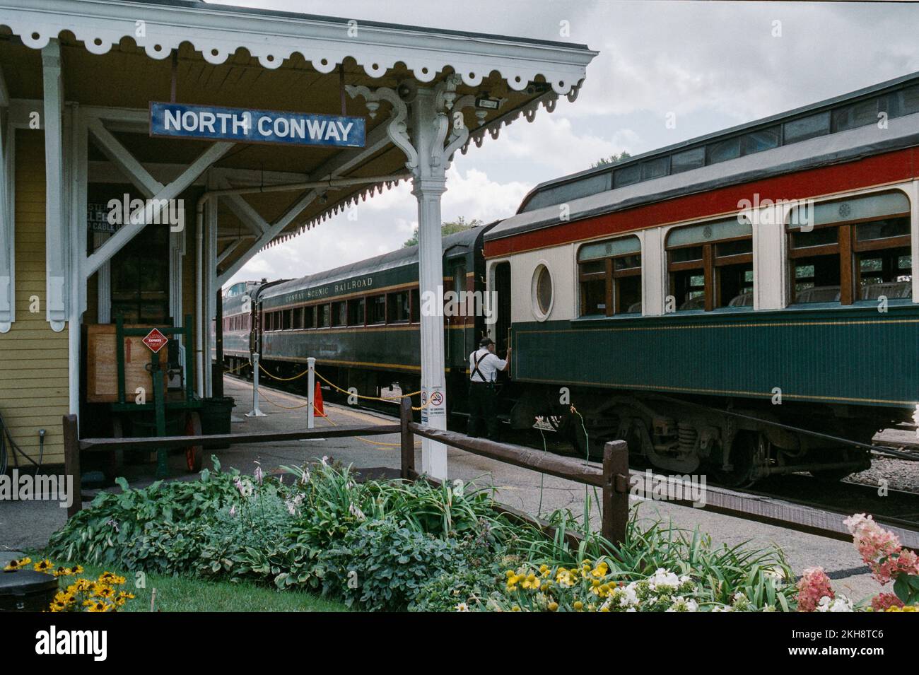 A vintage red and yellow diesel train engine in the crossing with the ...