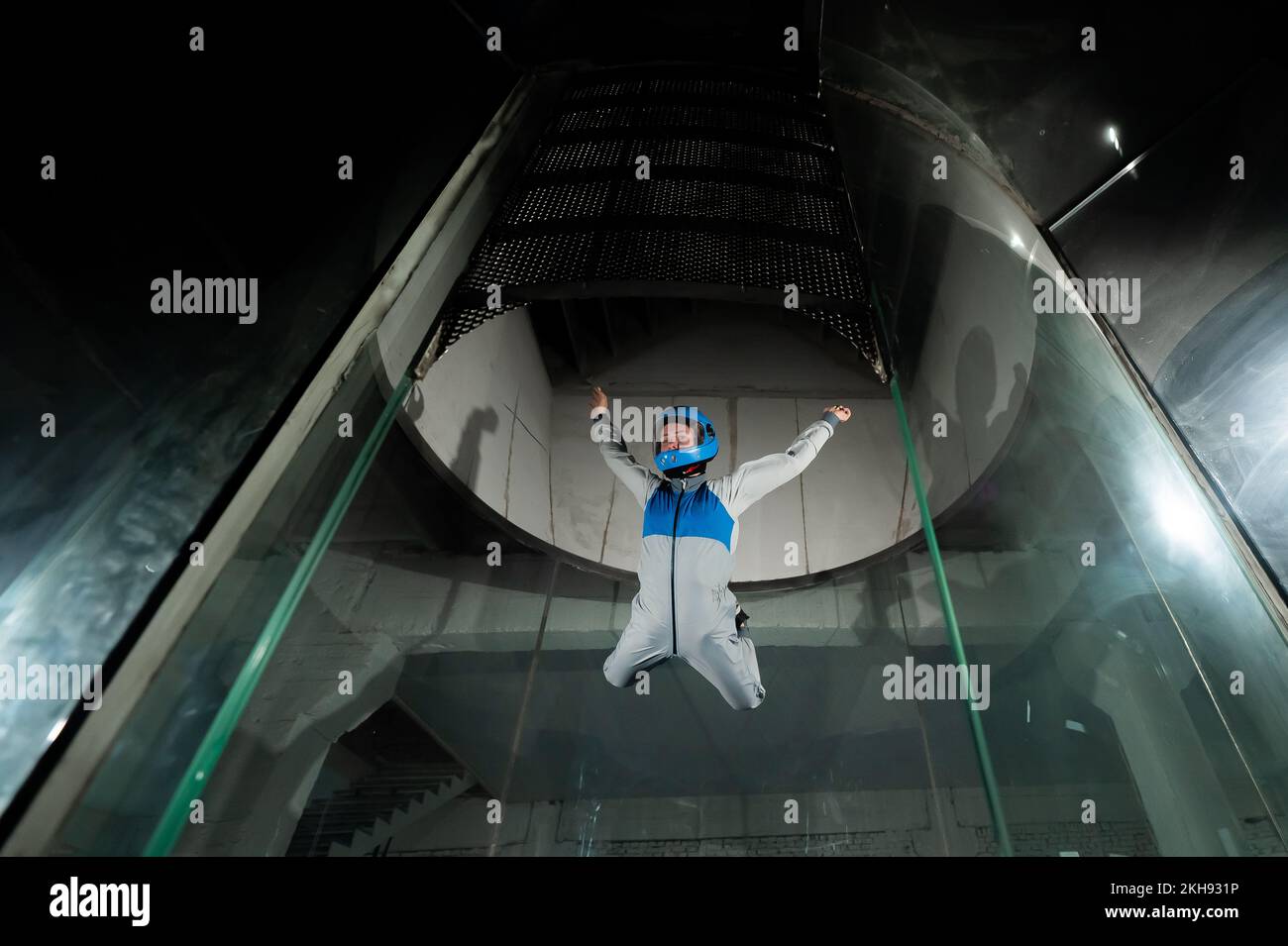 A woman flies in a wind tunnel. Free fall simulator Stock Photo - Alamy