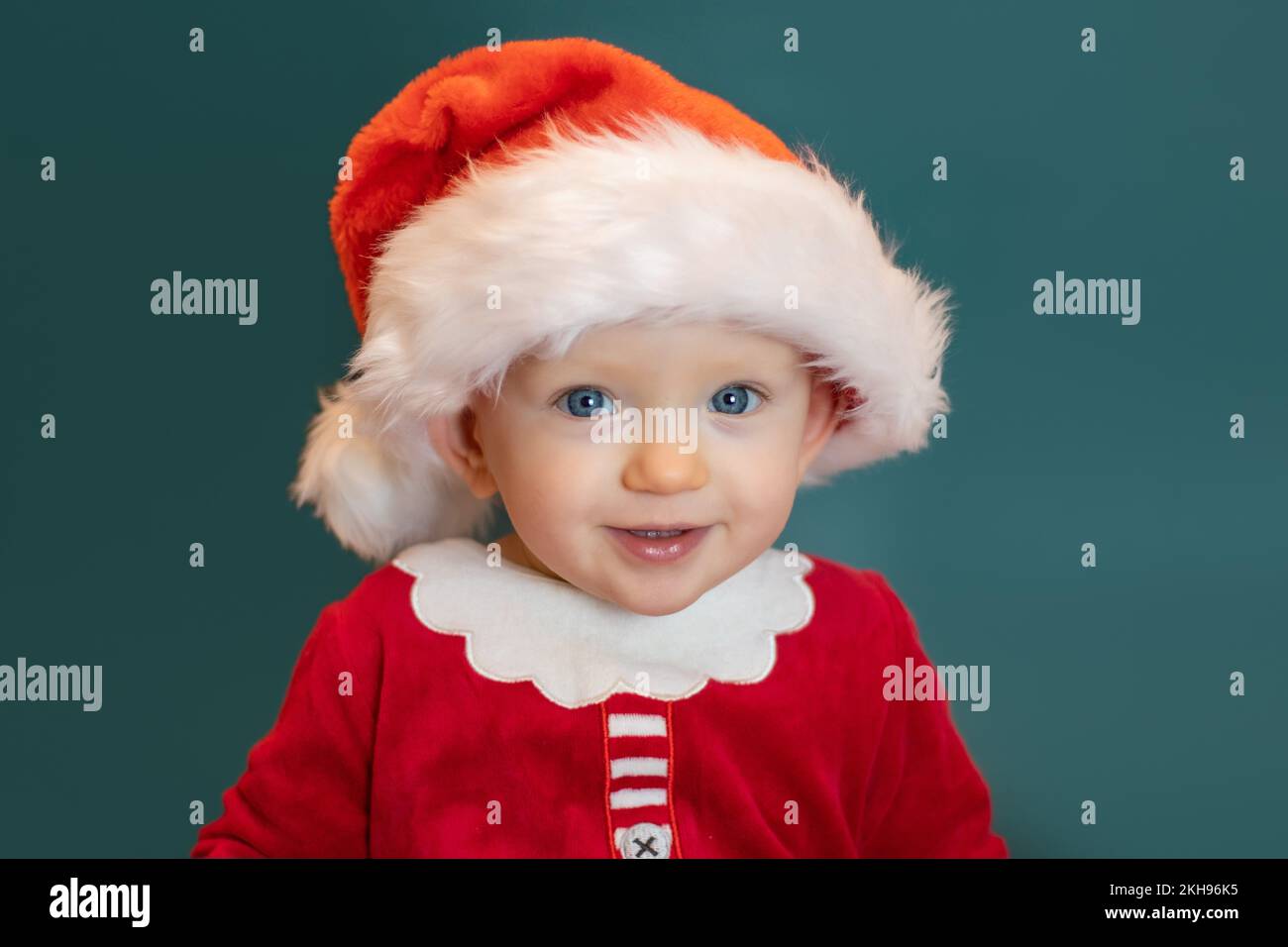 portrait little cute baby in santa costume on green background Stock ...