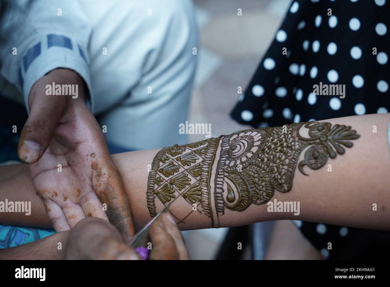 A horizontal image of wedding henna decorations on hand n Chandigarth ...