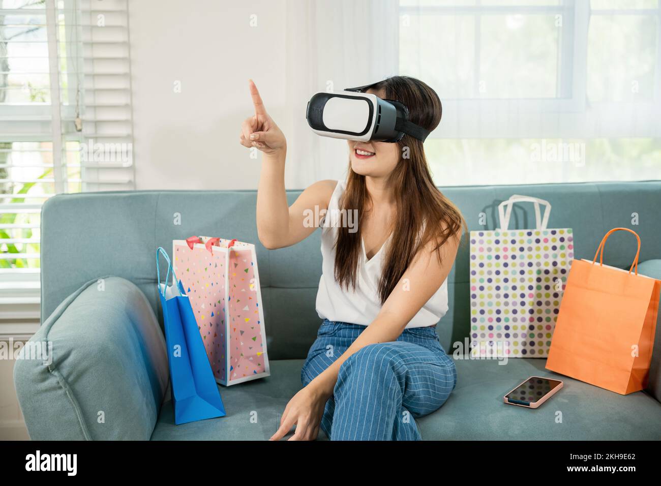 Happy young woman customer wearing 3d VR glasses virtual reality ...
