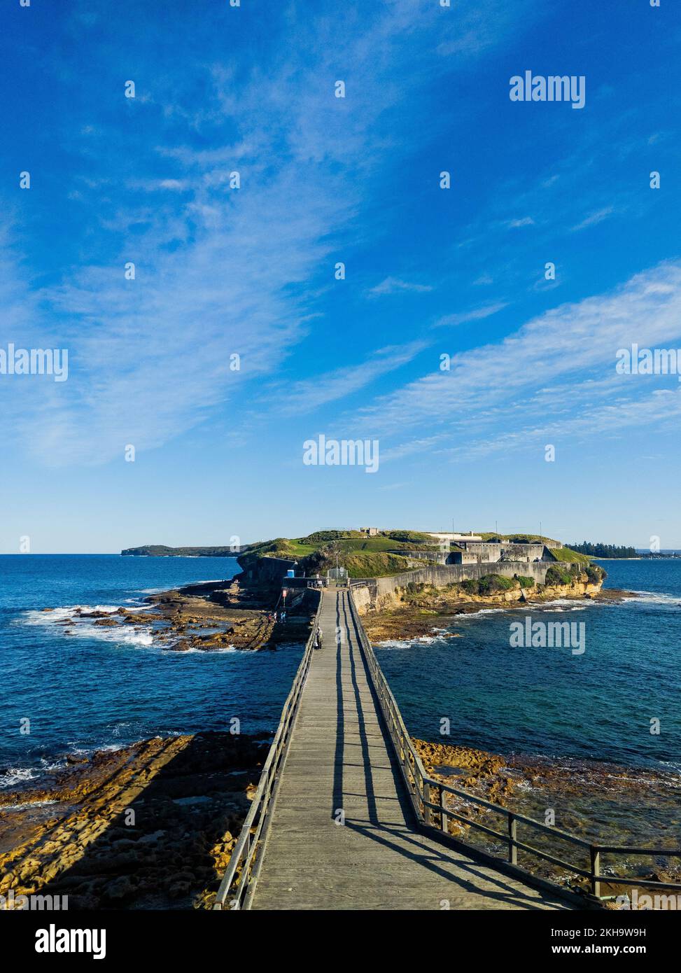 A vertical image of a wooden bridge joining the coastline with the ...