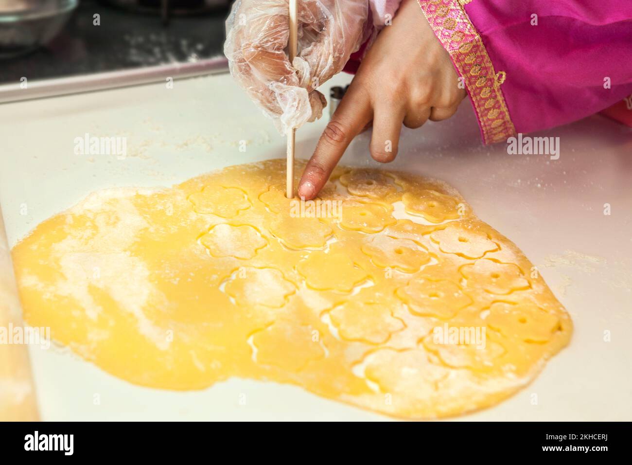 Teacher prepares dough for donuts, yuyu, at Tunisian cooking class in ...