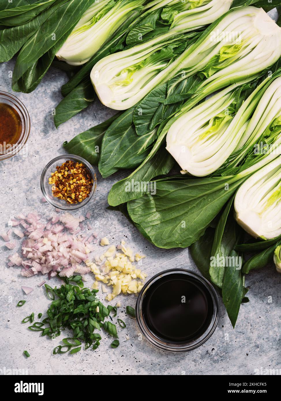 A vertical top view of Bok choy with other vegetables on grungy ...