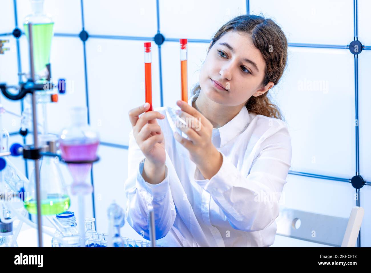 comparison of two test tubes with red liquid in a chemistry laboratory ...