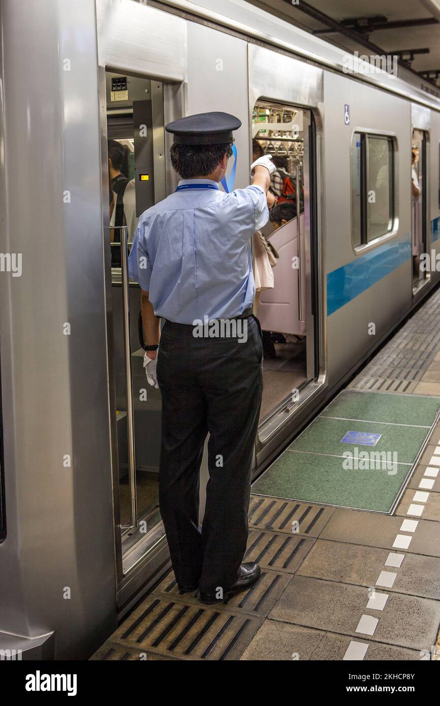 Trainman signals engineer to depart subway Station in Tokyo, Japan ...