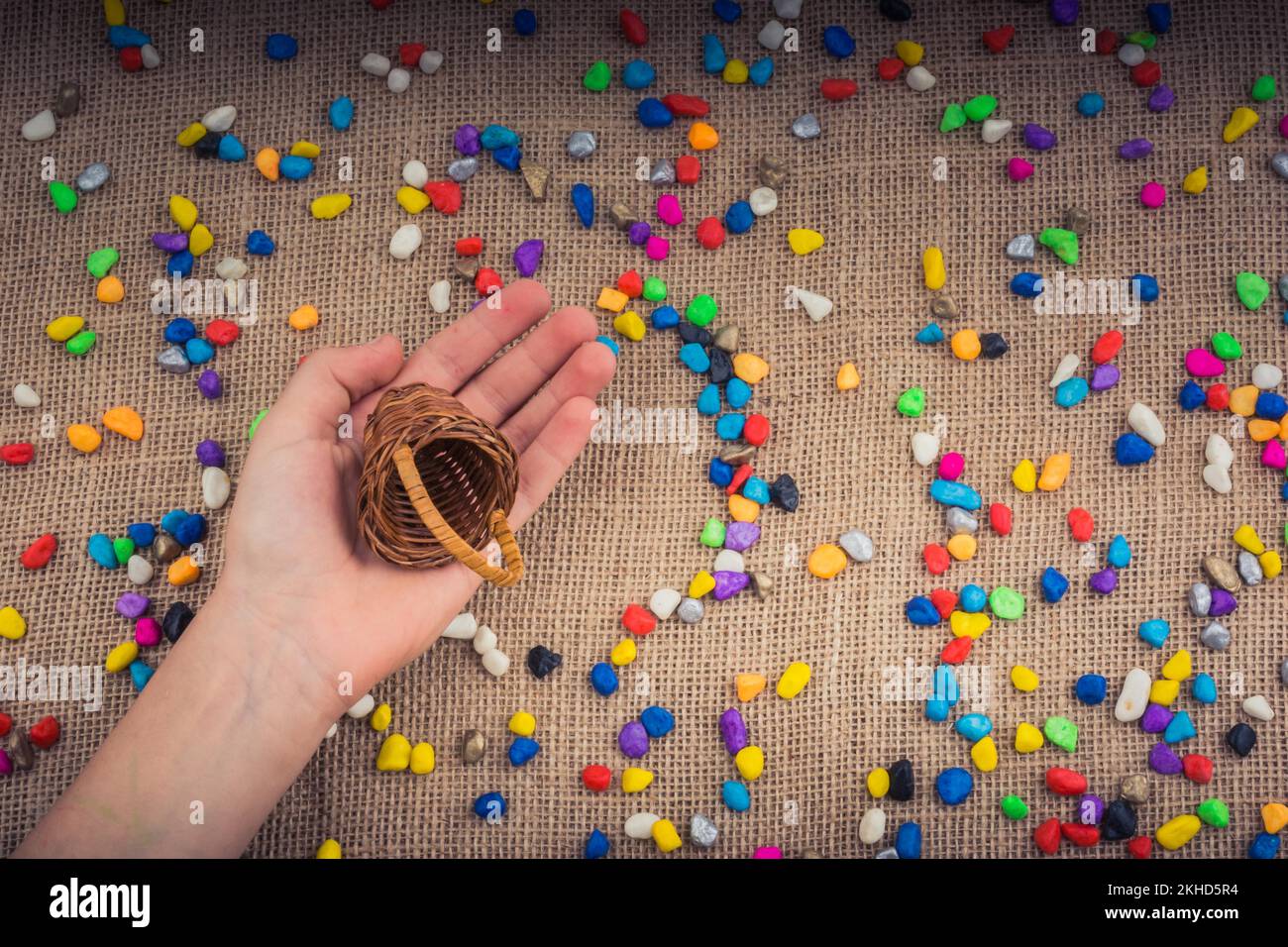 Bucket of colorful pebbles spill on background Stock Photo - Alamy