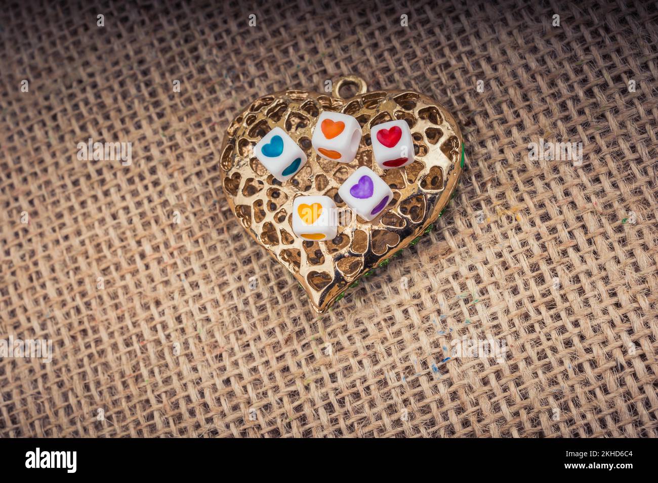 Heart cubes on Heart shaped gold color object Stock Photo - Alamy
