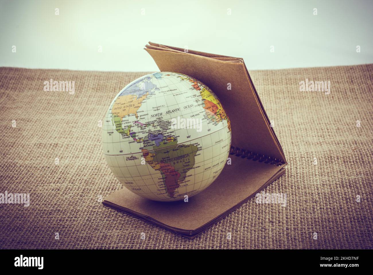 Globe with a notebook beside placed on canvas Stock Photo - Alamy