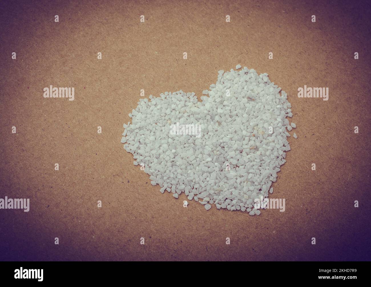 White heart stone on sand hi-res stock photography and images - Alamy