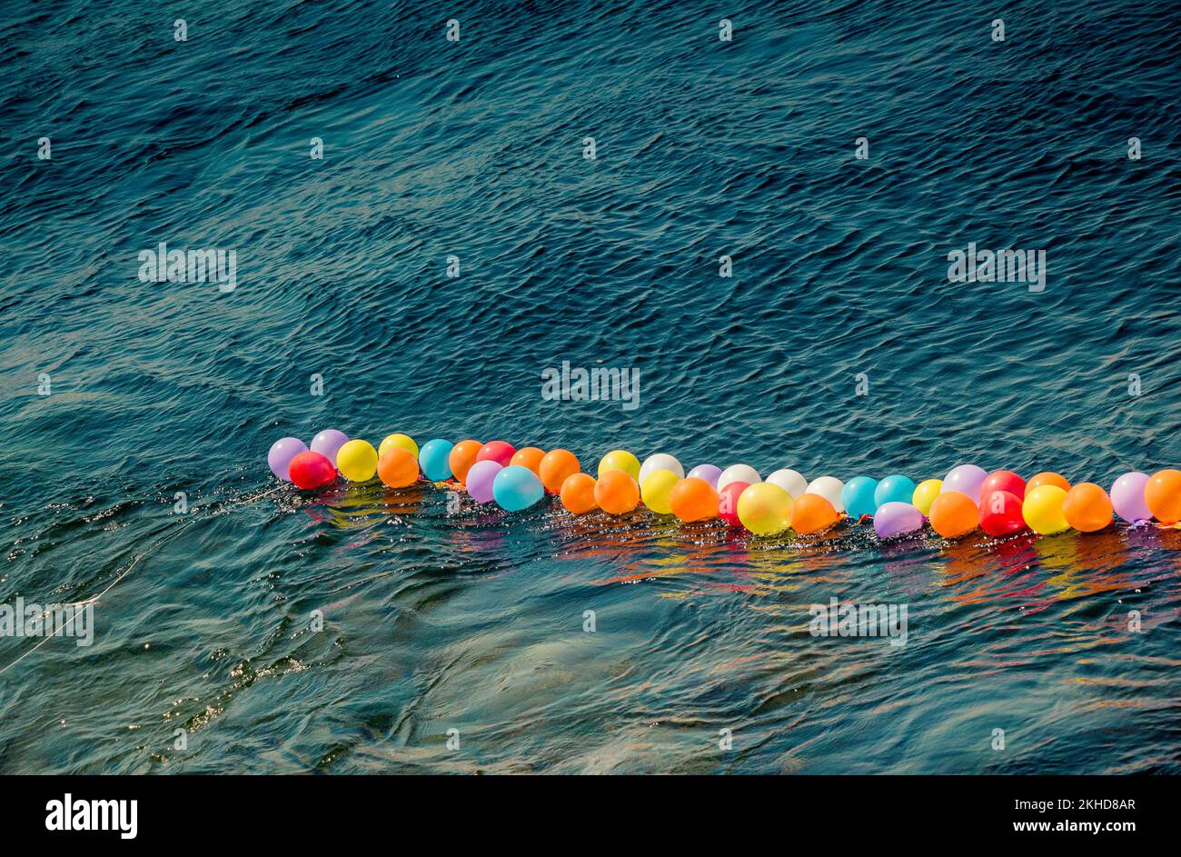 Balloon on a string on water for shooting game Stock Photo - Alamy