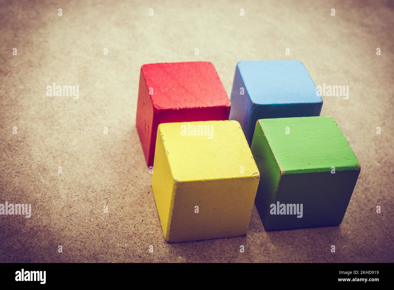 Colorful building blocks on a brown background Stock Photo - Alamy