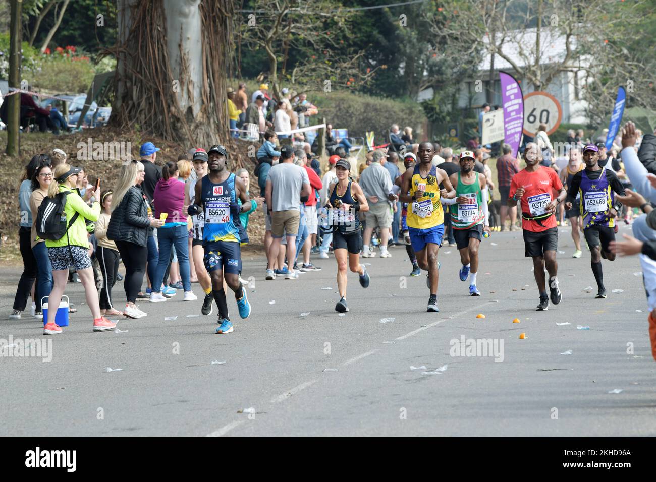 Crowd cheering, spectator support, athletes running race, 95th Comrades ...