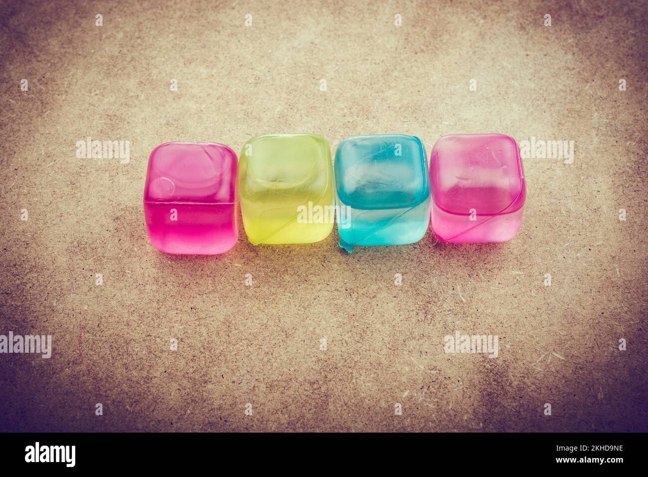 Fake colorful ice cubes on a brown background Stock Photo - Alamy
