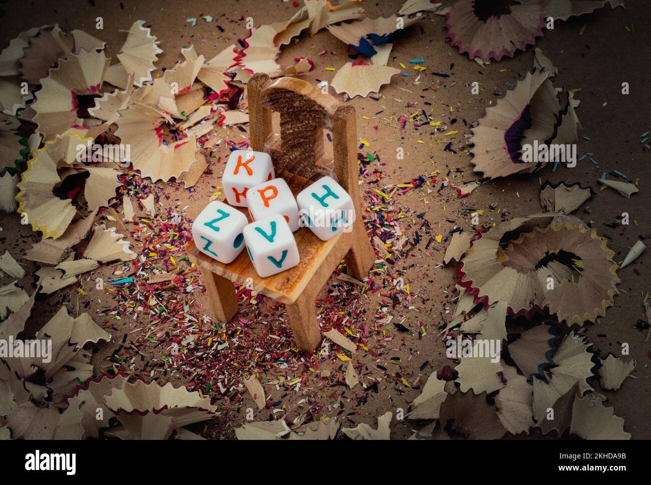 Colorful letter cubes on chair in pencil trash Stock Photo - Alamy