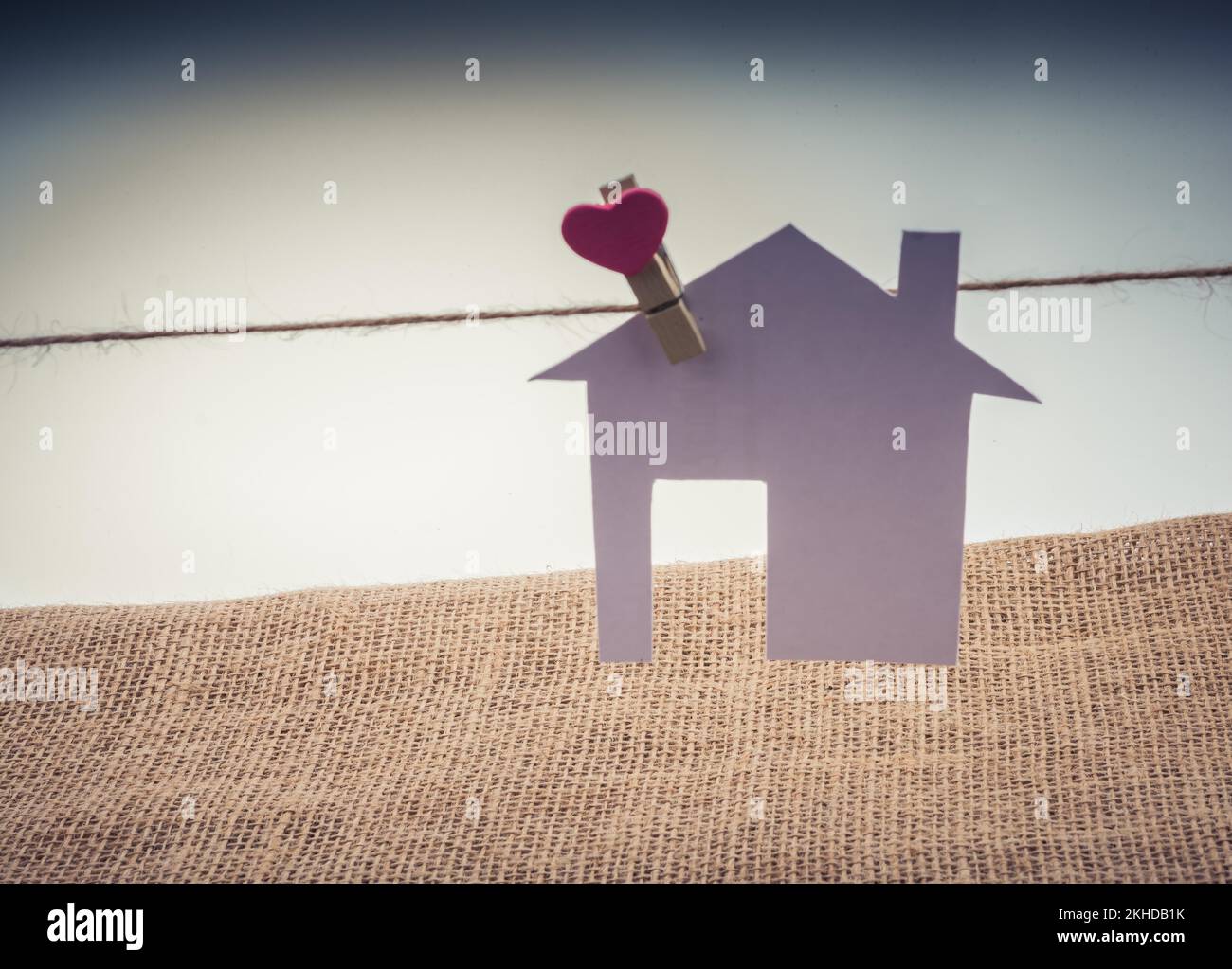 Little paper house attached to a string with a heart clip Stock Photo ...