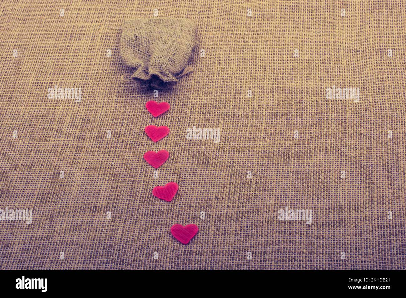 Heart shaped objects before a sack on canvas Stock Photo - Alamy