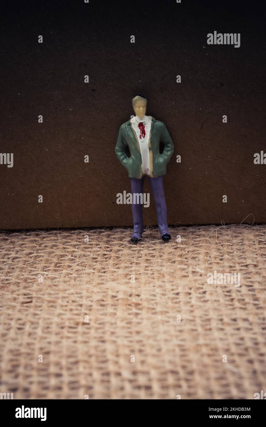 Man figurine trapped in the circle of a chain Stock Photo - Alamy