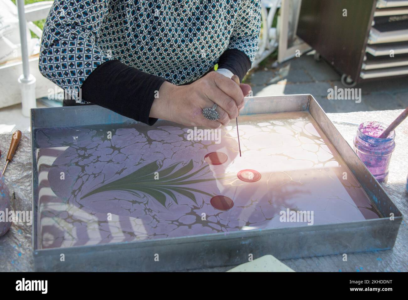 Hand drawing with stick stained inks on water surface Stock Photo - Alamy