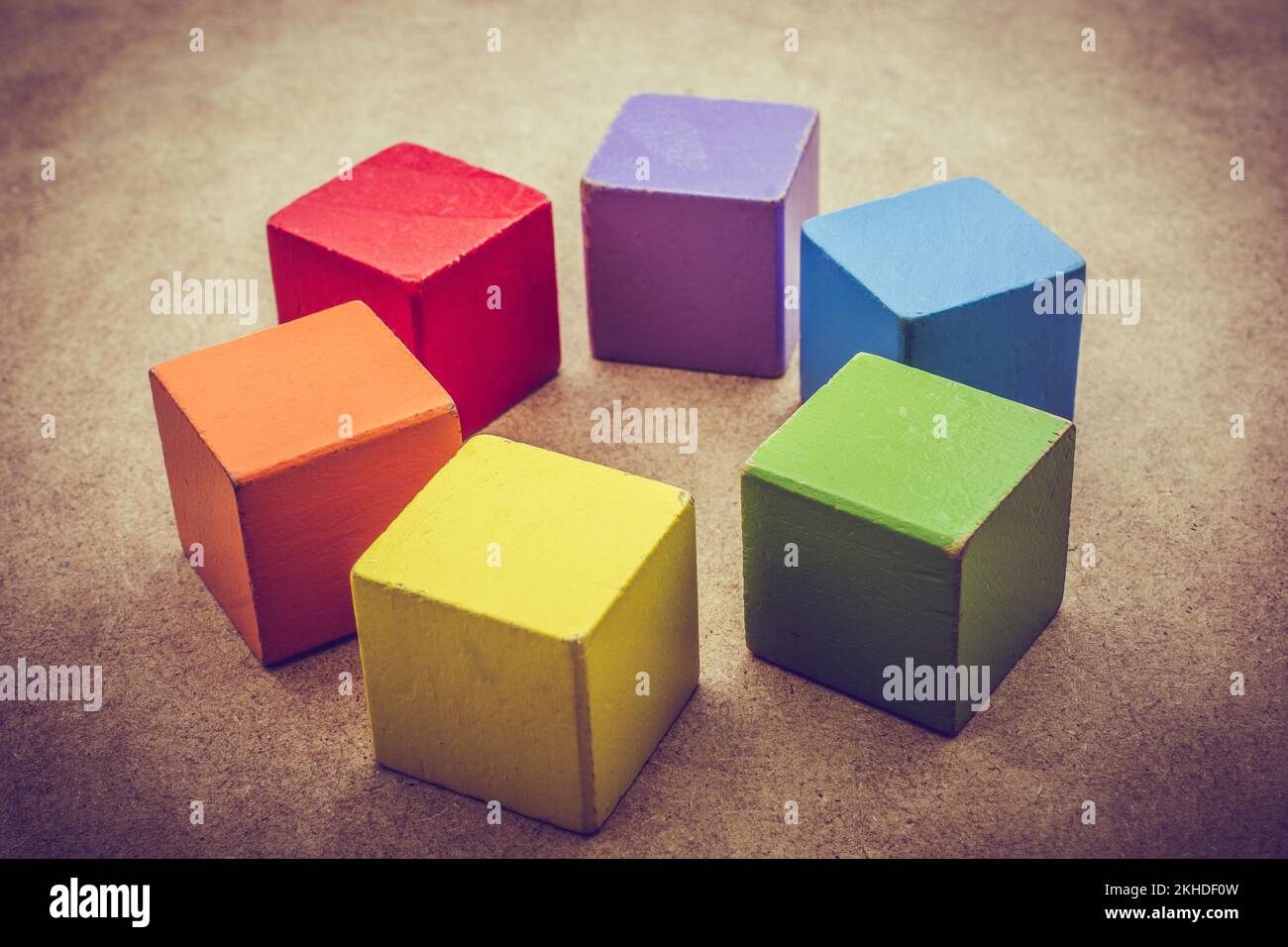 Colorful building blocks on a brown background Stock Photo - Alamy
