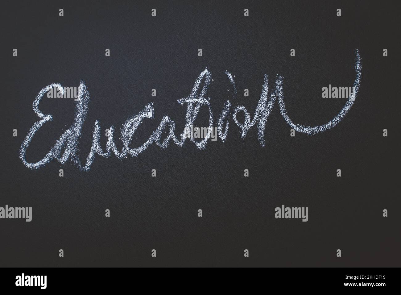 Hand written word EDUCATION with white chalk on black board Stock Photo ...