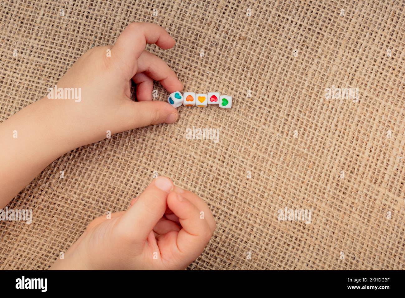 Little cubes with heart shape in hand on canvas Stock Photo - Alamy