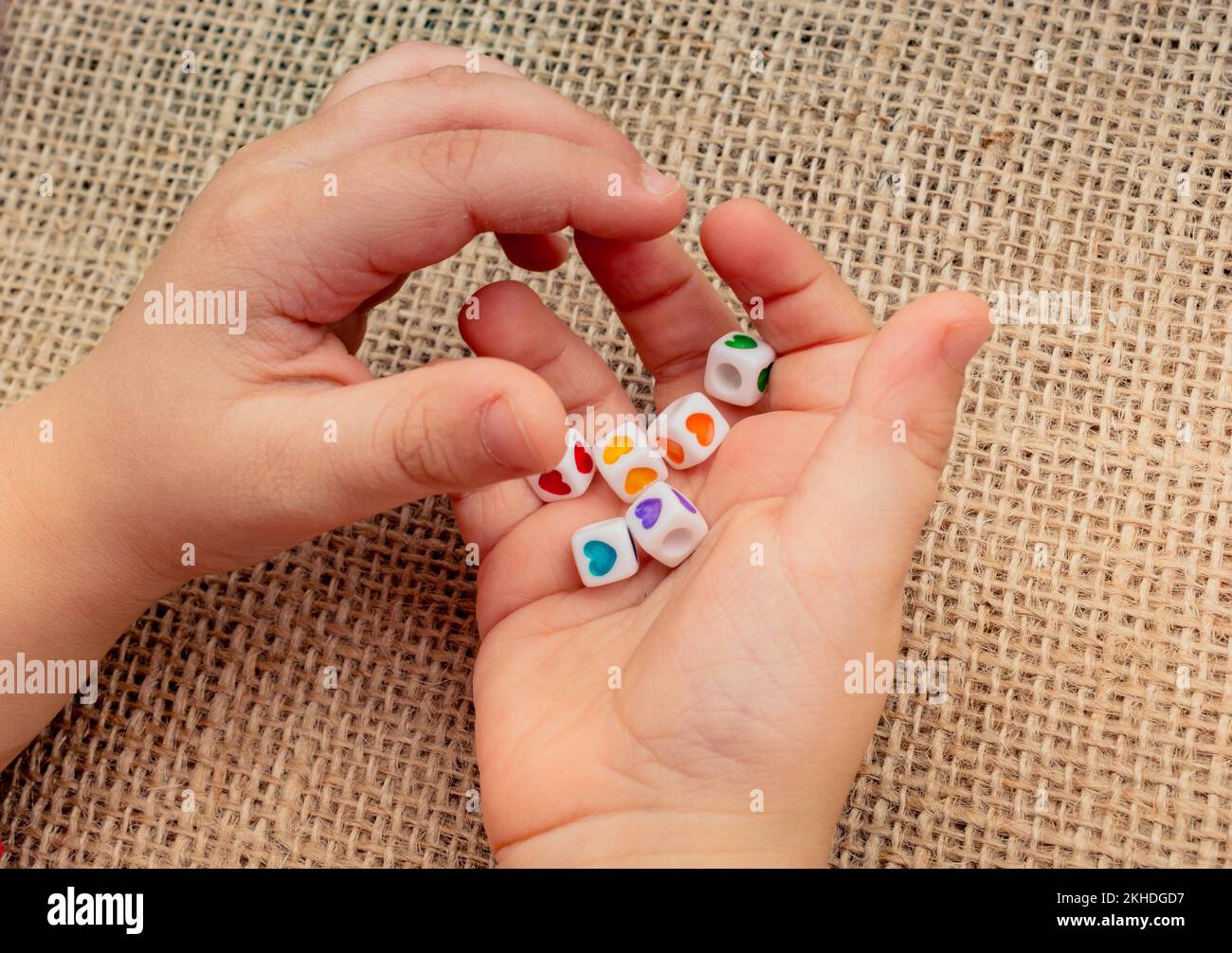 Little cubes with heart shape in hand on canvas Stock Photo - Alamy