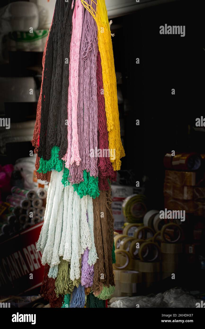 Empty mesh bags of various color at a market place Stock Photo - Alamy