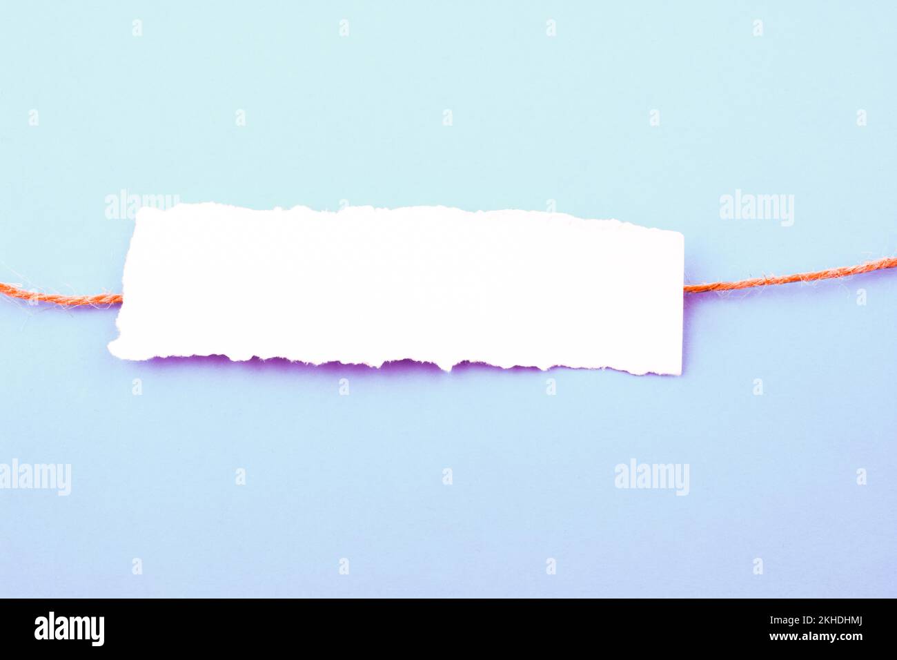White color note paper placed on a string on a white background Stock ...