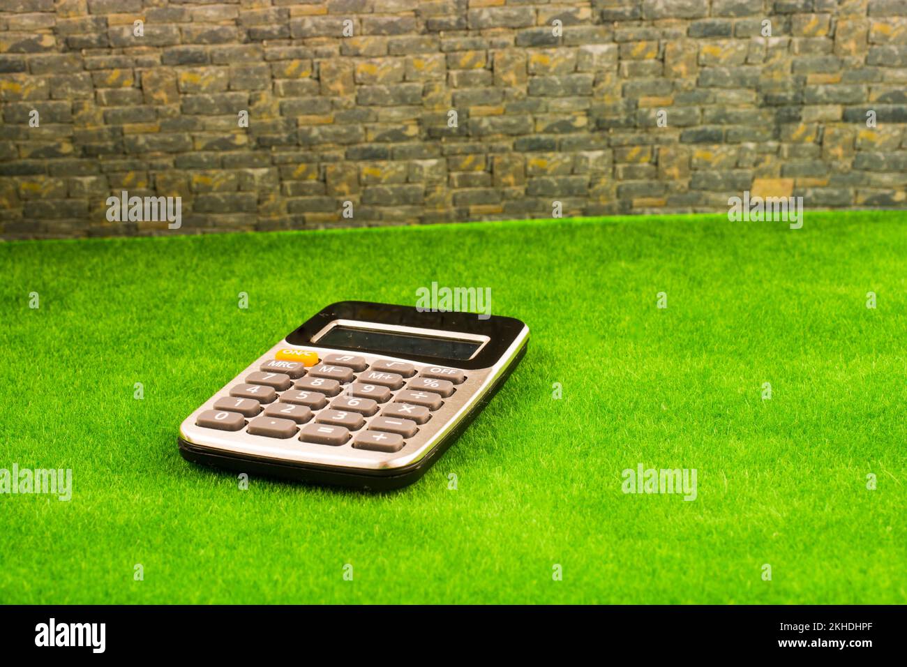 Calculator placed in green grass Stock Photo - Alamy