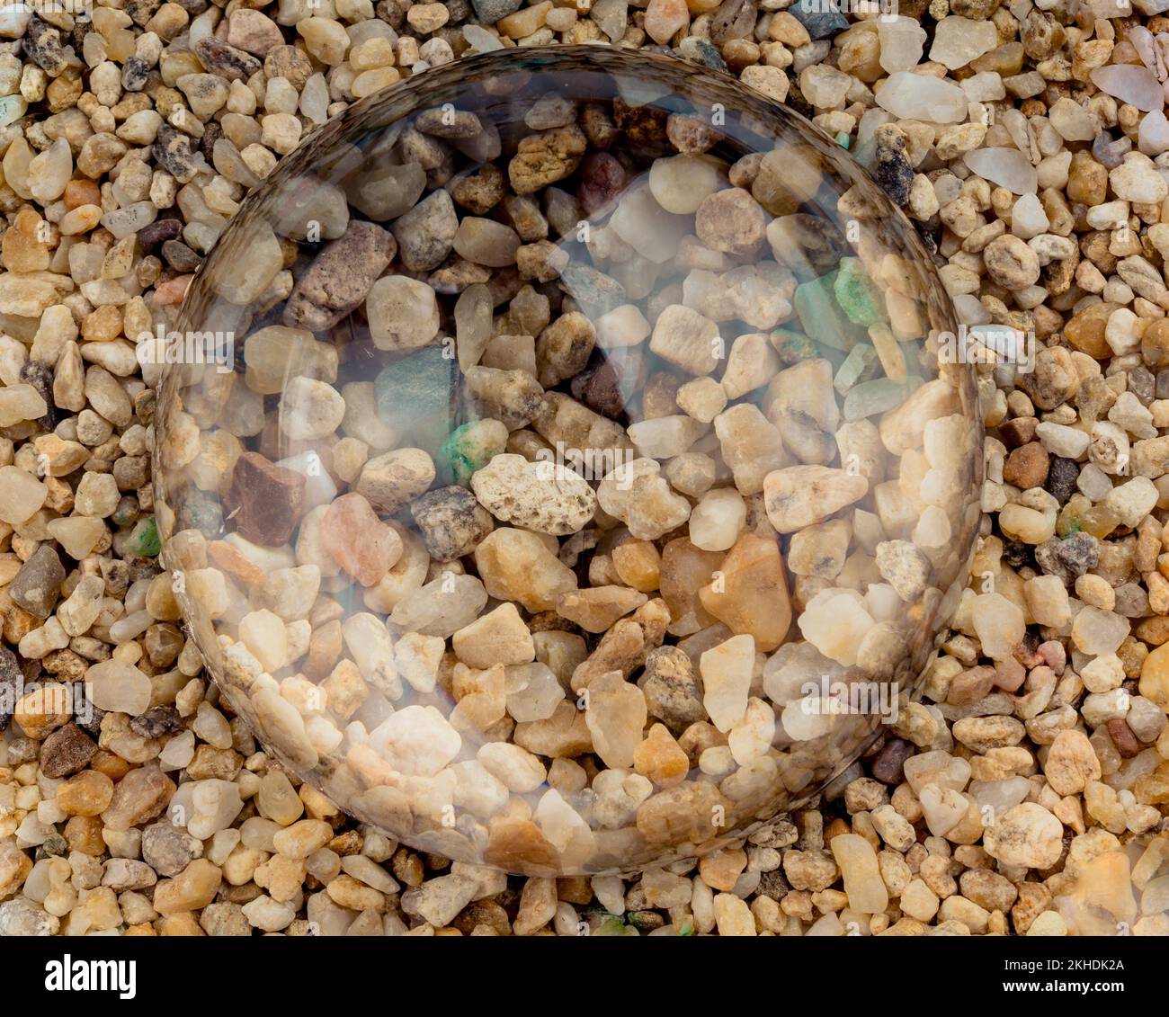 Little gravel stones as a background under a glass Stock Photo - Alamy