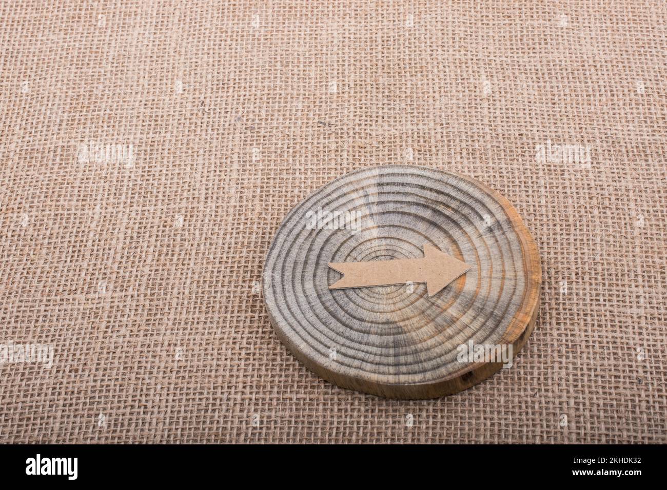 Arrow sign cut out of brown paper in view Stock Photo - Alamy