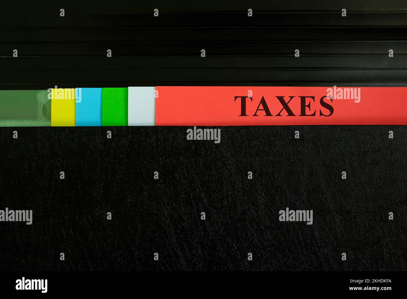Taxes file in black binder folder. Tax management business and ...
