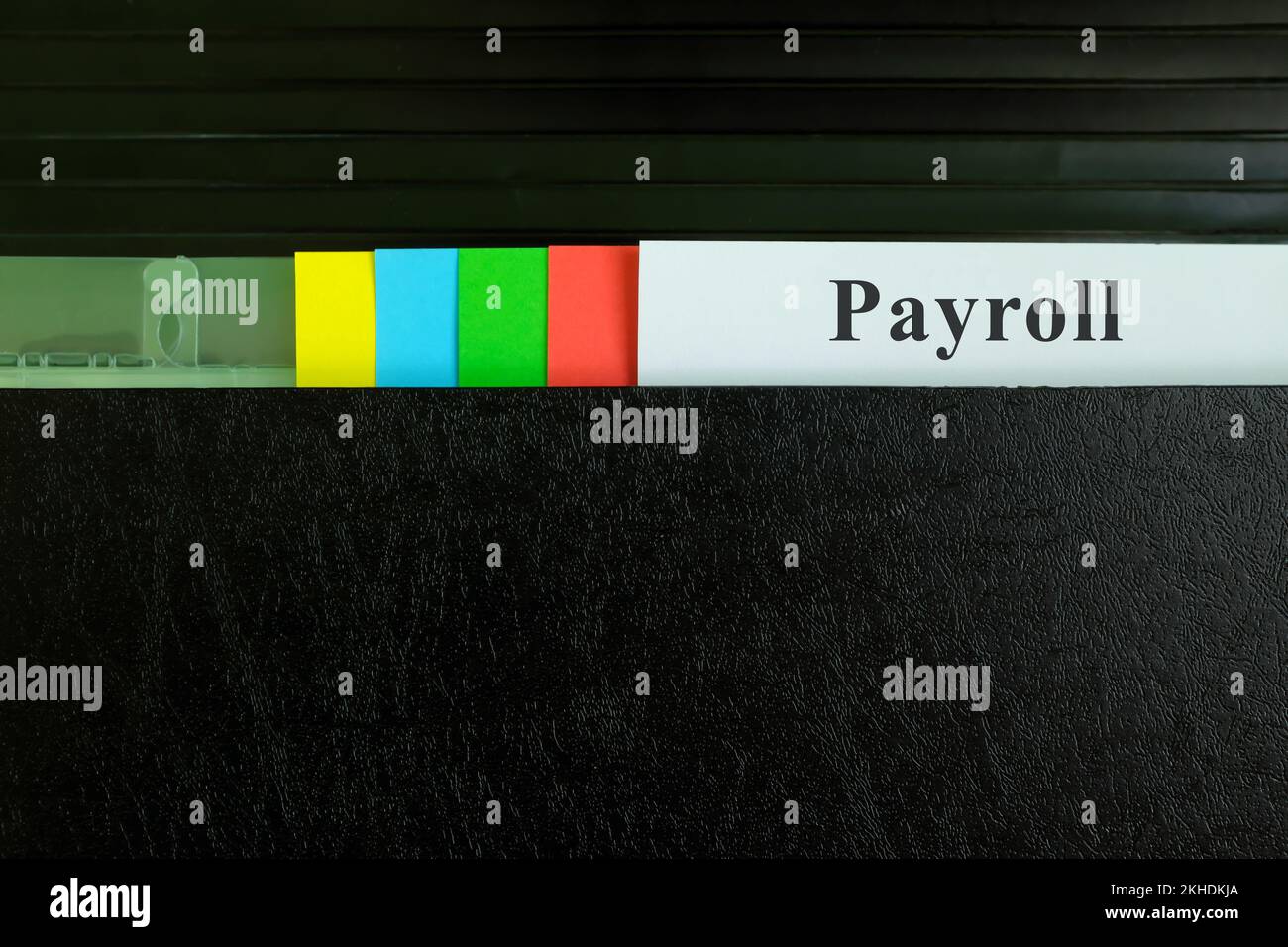 Payroll file in black binder folder. Human resources and accounting ...