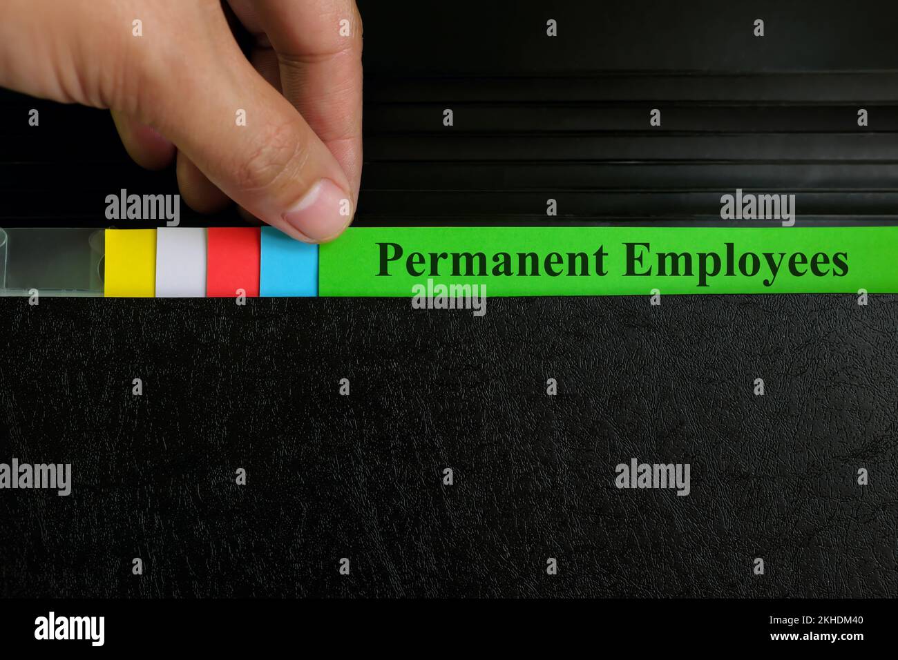 Hand picking permanent employees file record in black binder folder ...