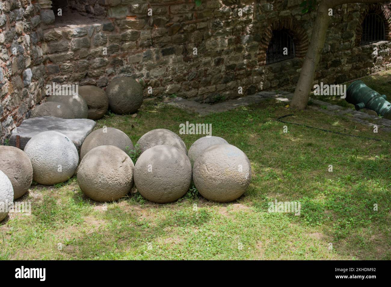 Round stone balls over green grassy background Stock Photo - Alamy