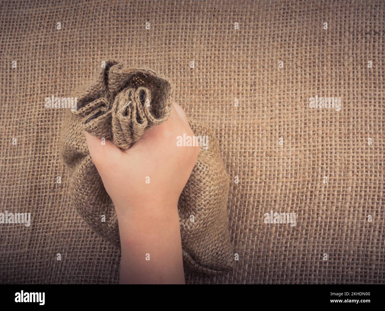 Hand holding an empty little sack made of linen Stock Photo - Alamy