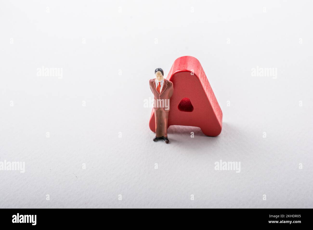 Man figurine and Letters of A of alphabet on white Stock Photo - Alamy