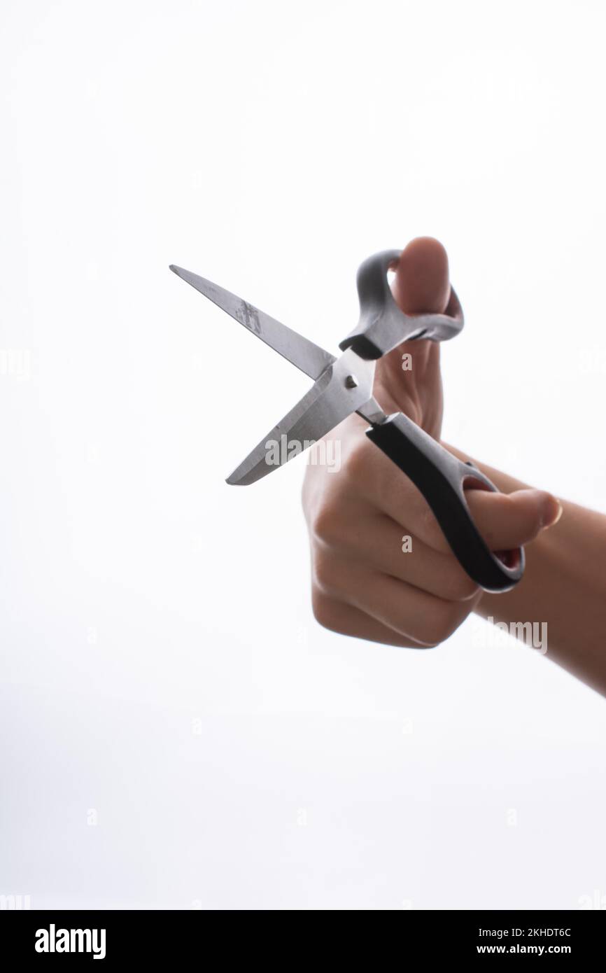 Hand holding steel scissors on a white backgruond Stock Photo - Alamy