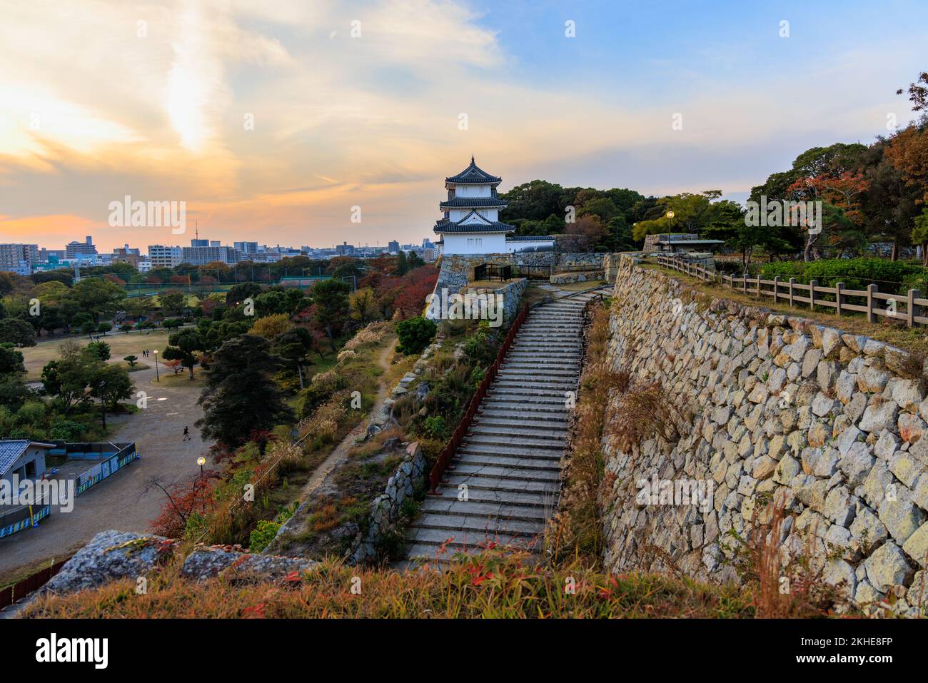 Stairs to castle lookout atop stone wall over city at sunset Stock ...