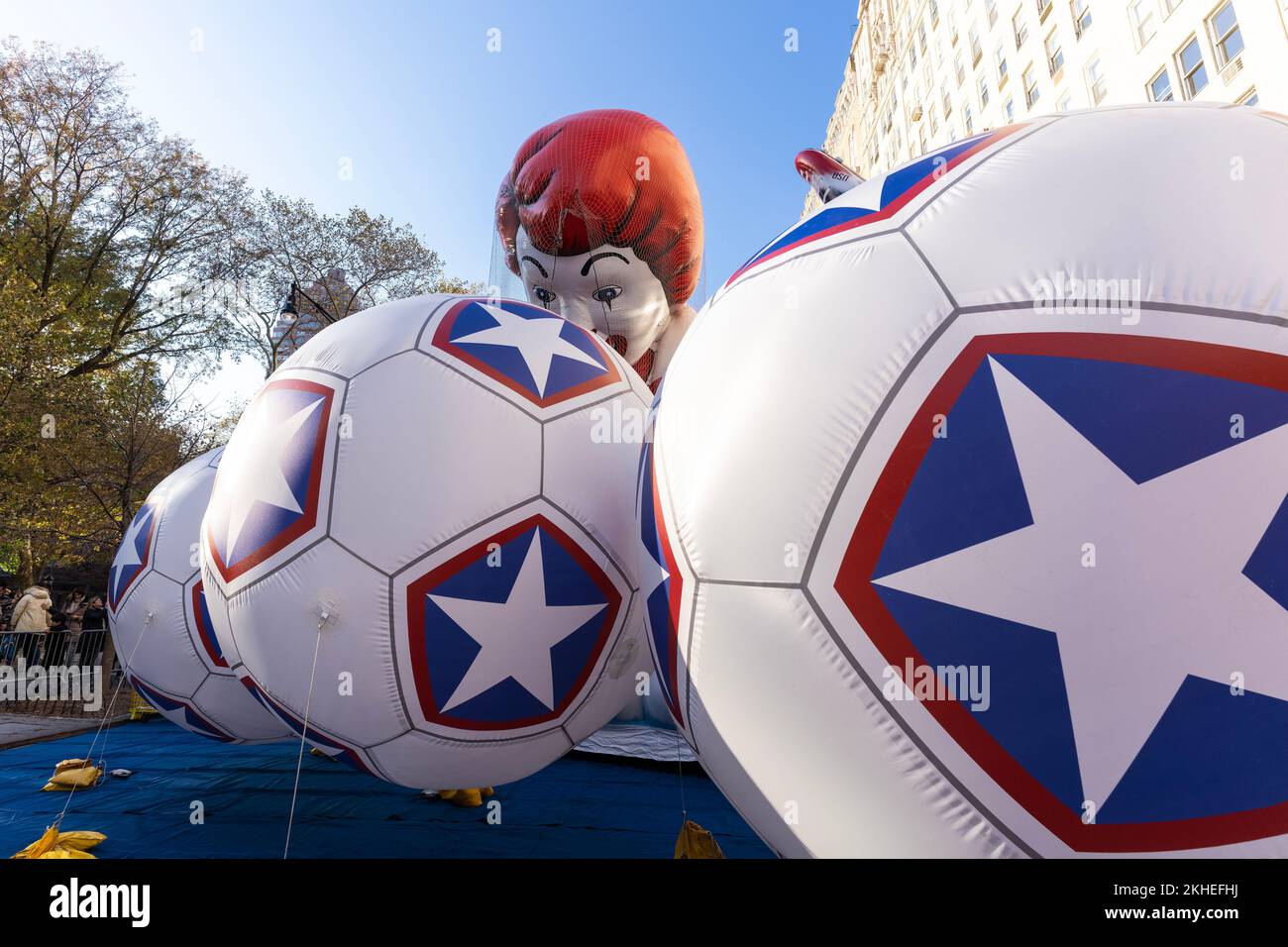 Ronald McDonald balloon looking down on Soccer balloons during ...