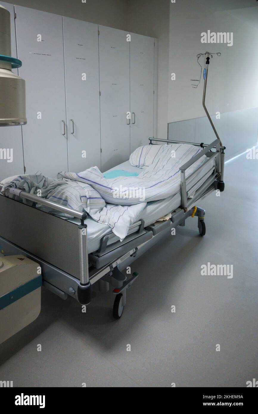 in the hospital corridor there is an empty patient bed Stock Photo - Alamy