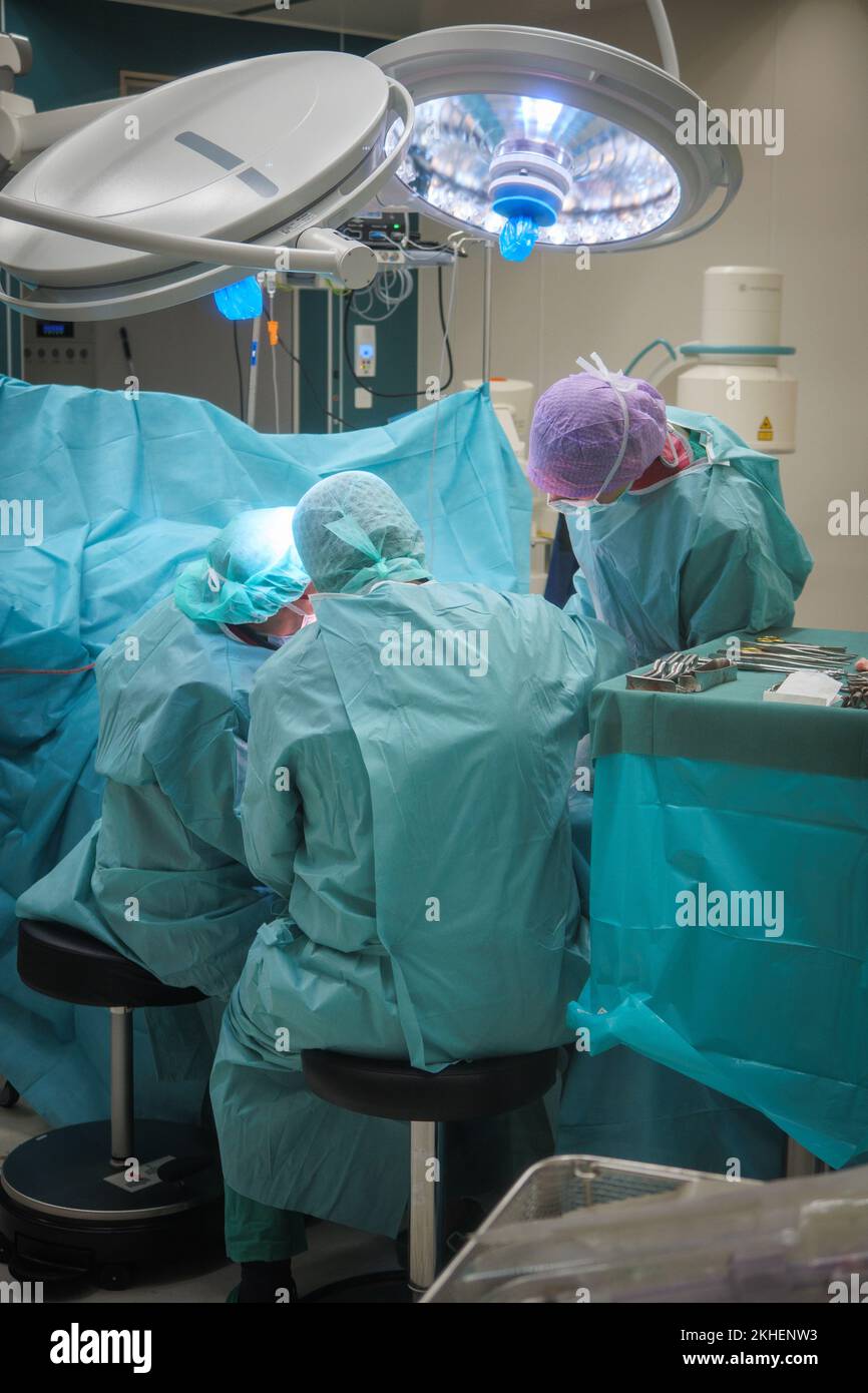 an operation is performed in an operating room in a hospital Stock ...
