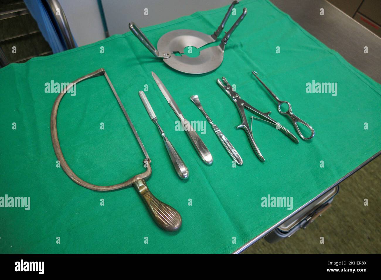 some various instruments for an amputation lie on a surgical cloth ...