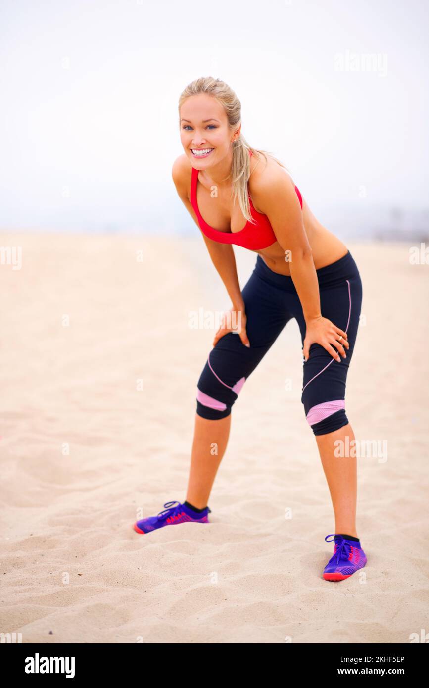 Just a quick breath before another 10k. Portrait of a young woman ...