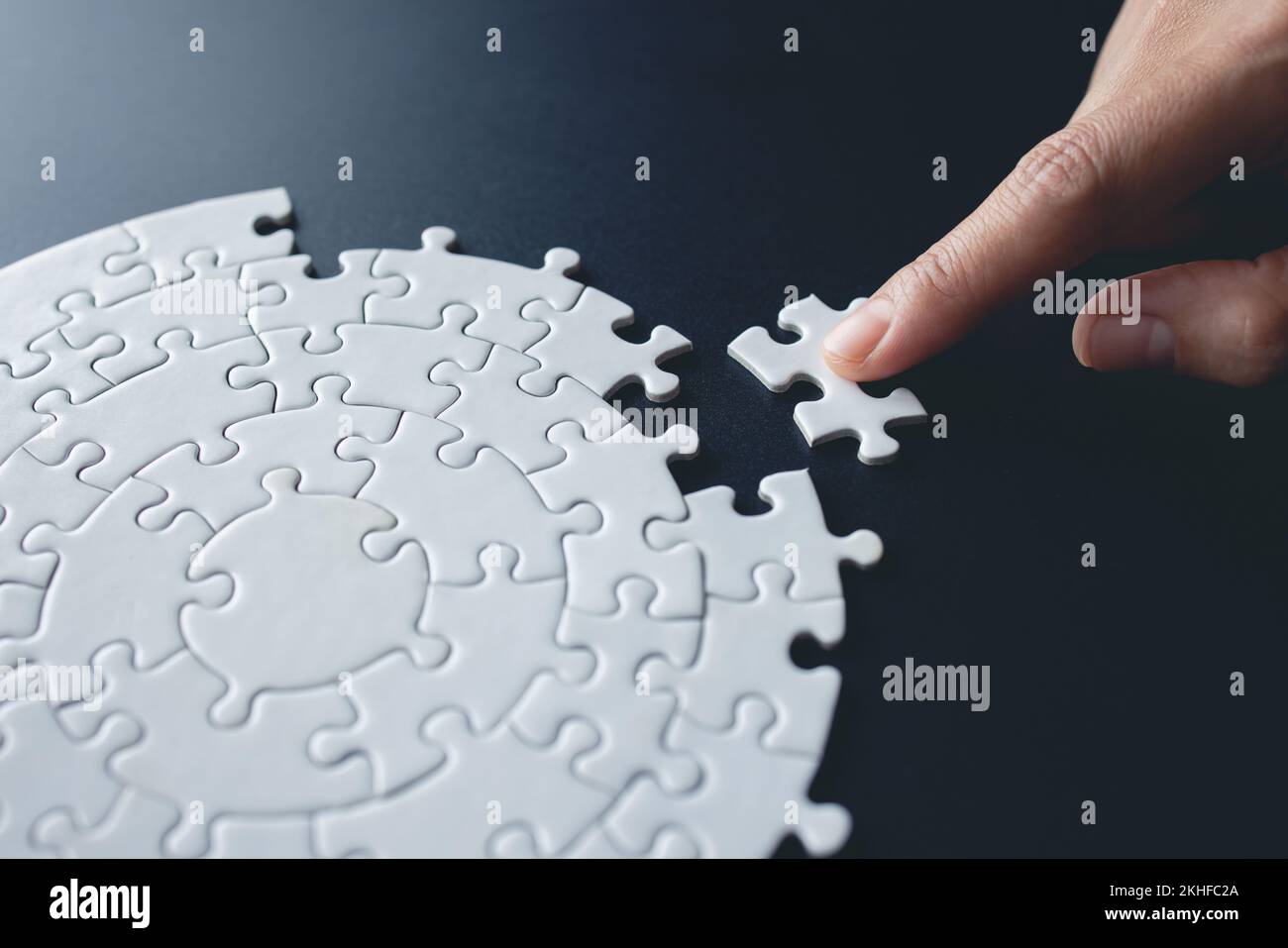 The correct solution. Teamwork, Solving and completing the task. Last piece of jigsaw puzzle ...